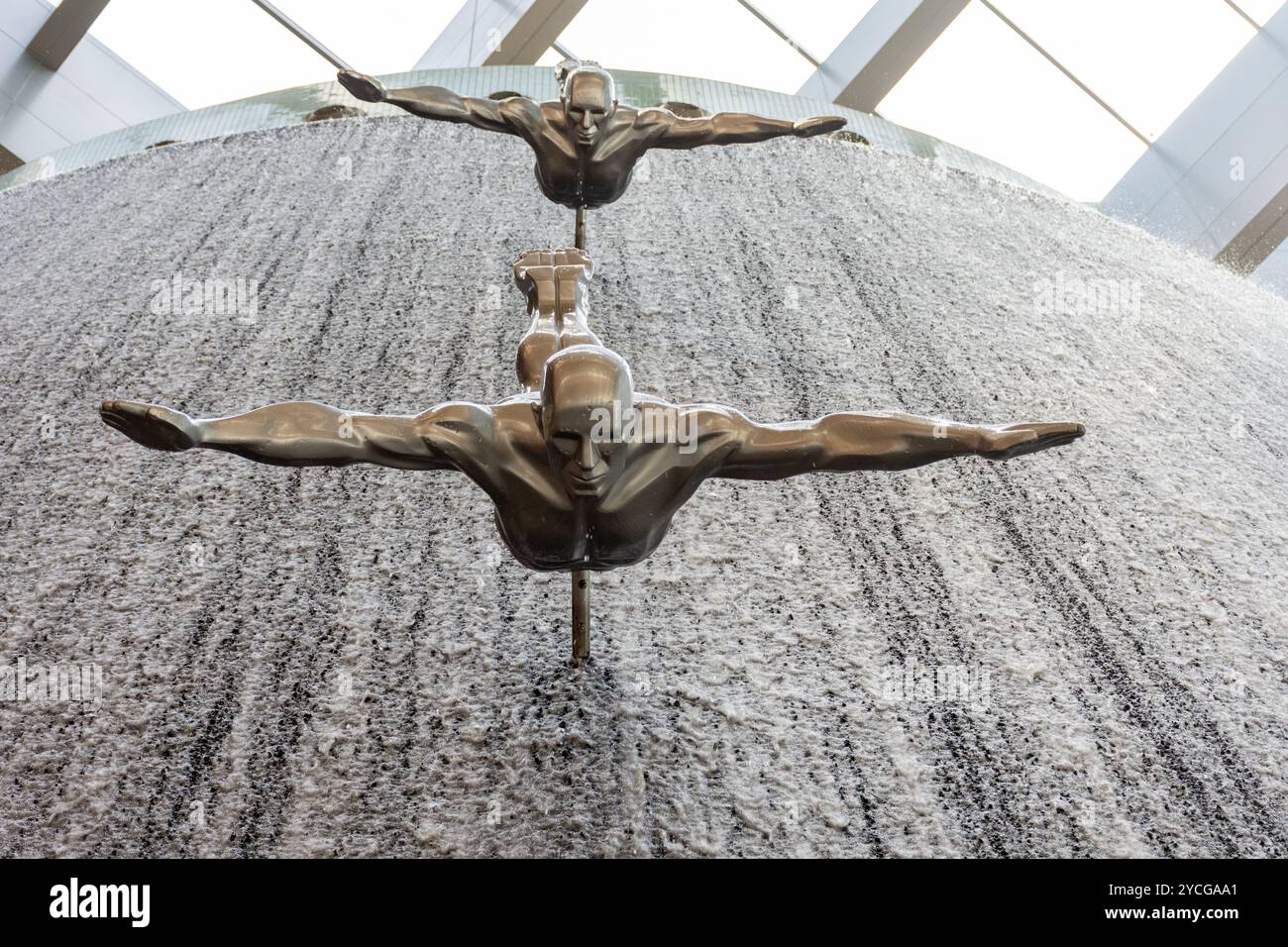 Diving men's sculptures of the iconic waterfall at the Dubai Mall in ...