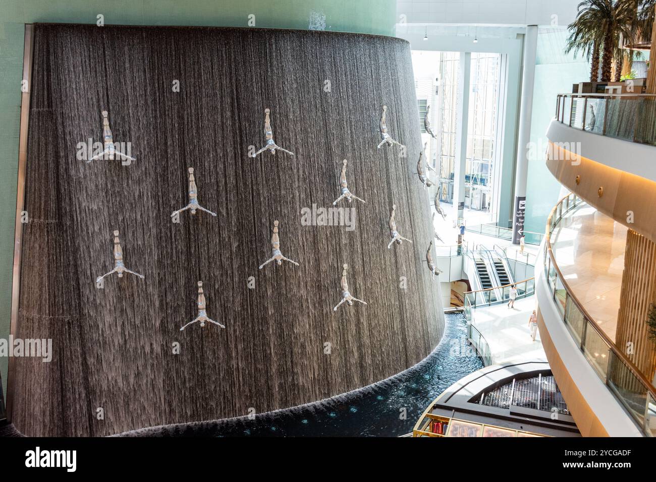 Diving men's sculptures of the iconic waterfall at the Dubai Mall in ...