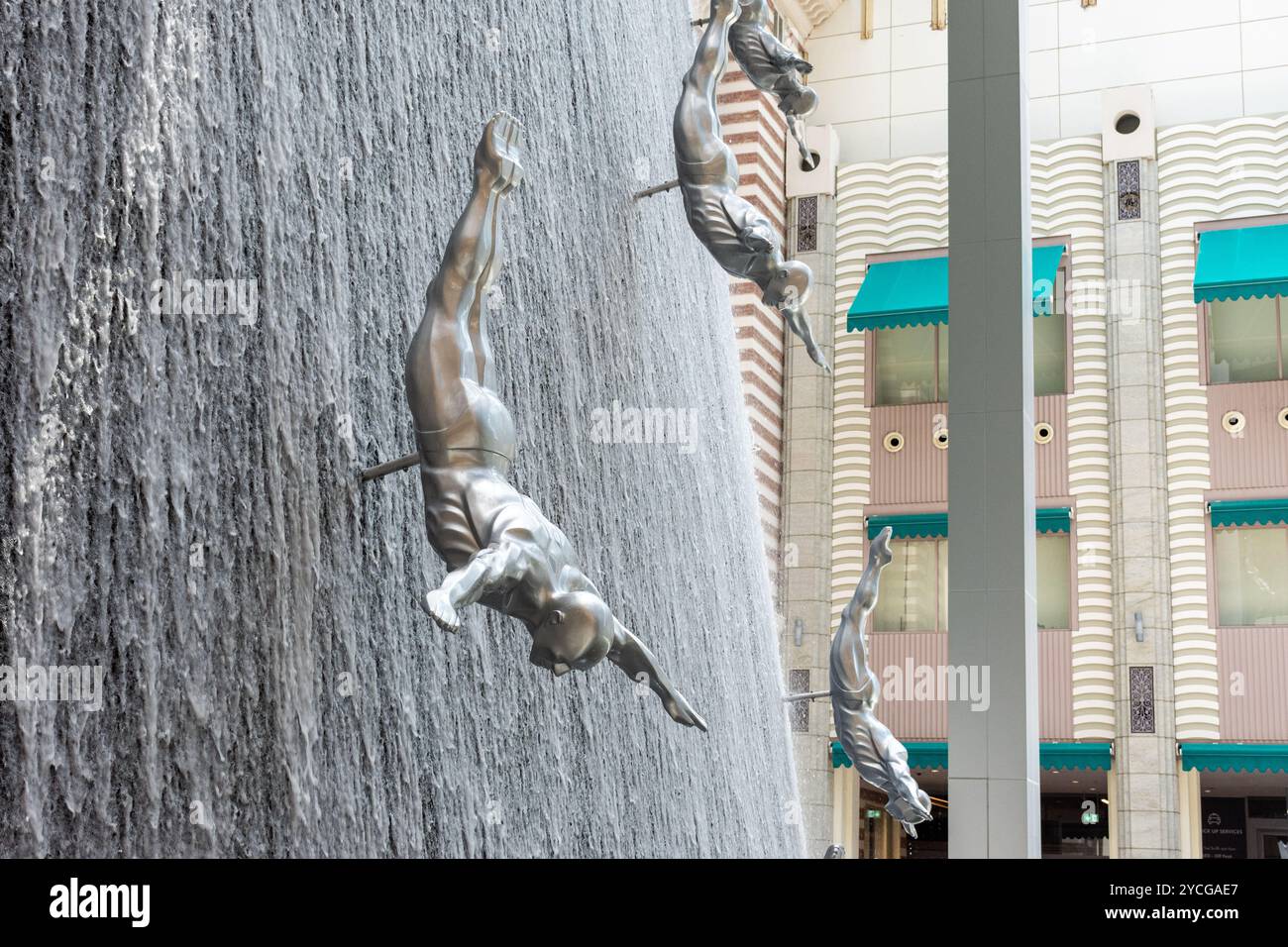 Diving men's sculptures of the iconic waterfall at the Dubai Mall in ...