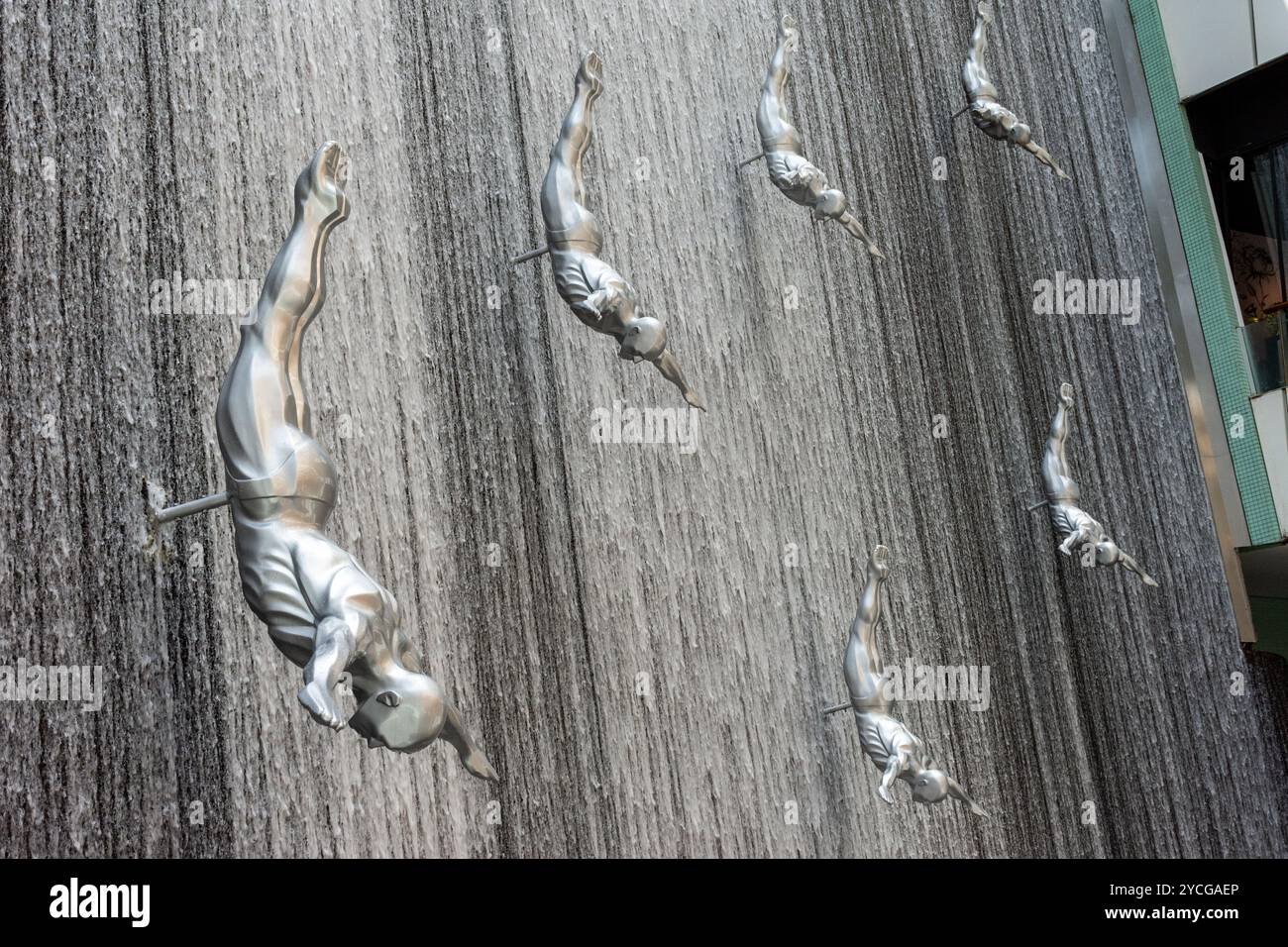 Diving men's sculptures of the iconic waterfall at the Dubai Mall in ...