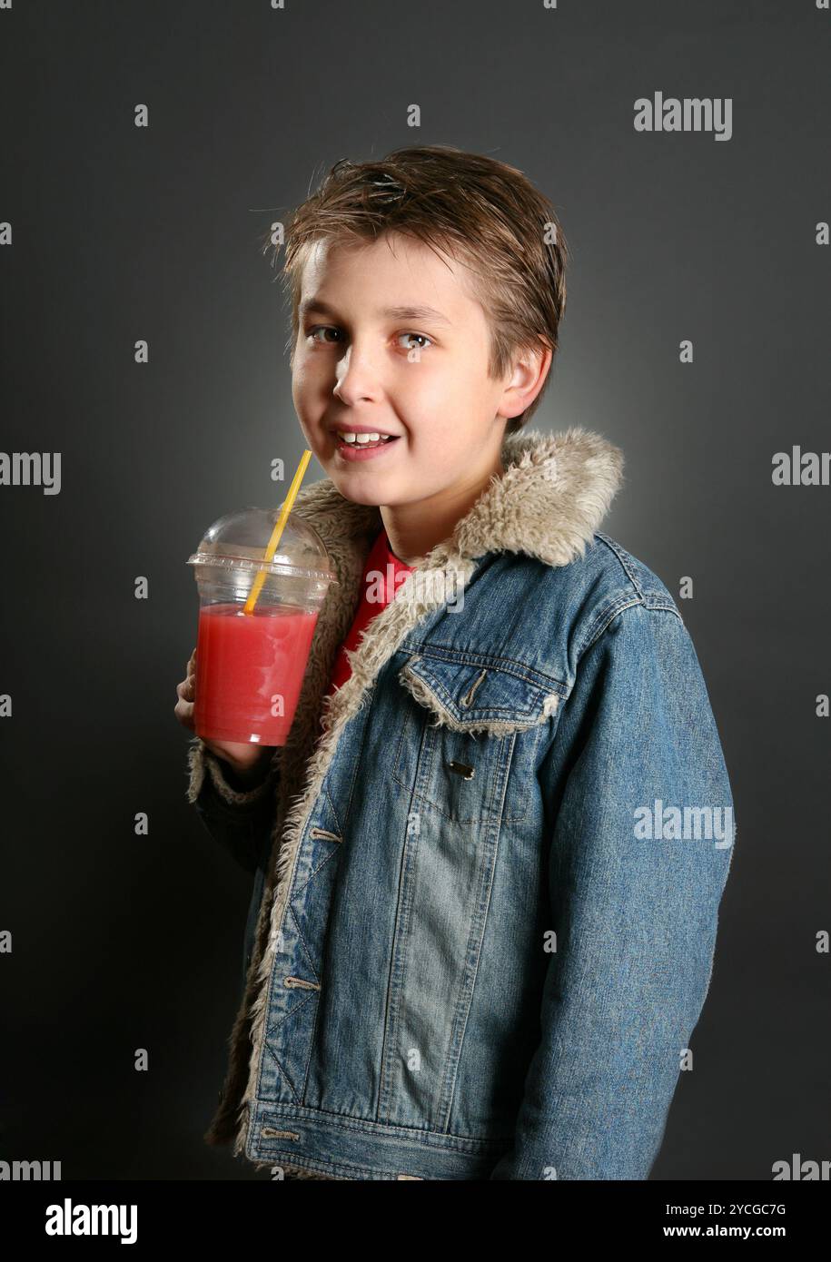 A beautiful young child drinking healthy fruit juice containing apple ...