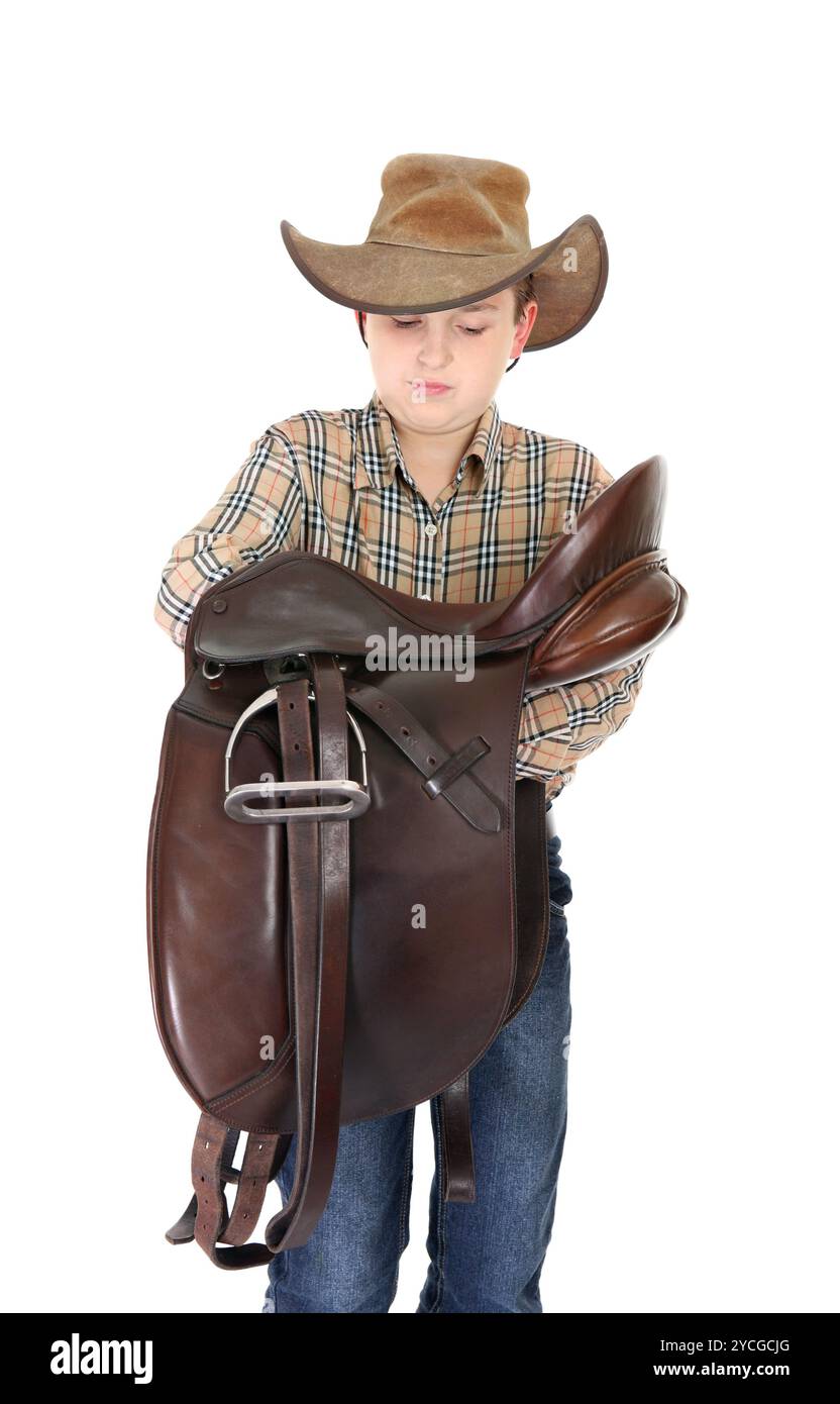 Country boy carrying a saddle Stock Photo - Alamy