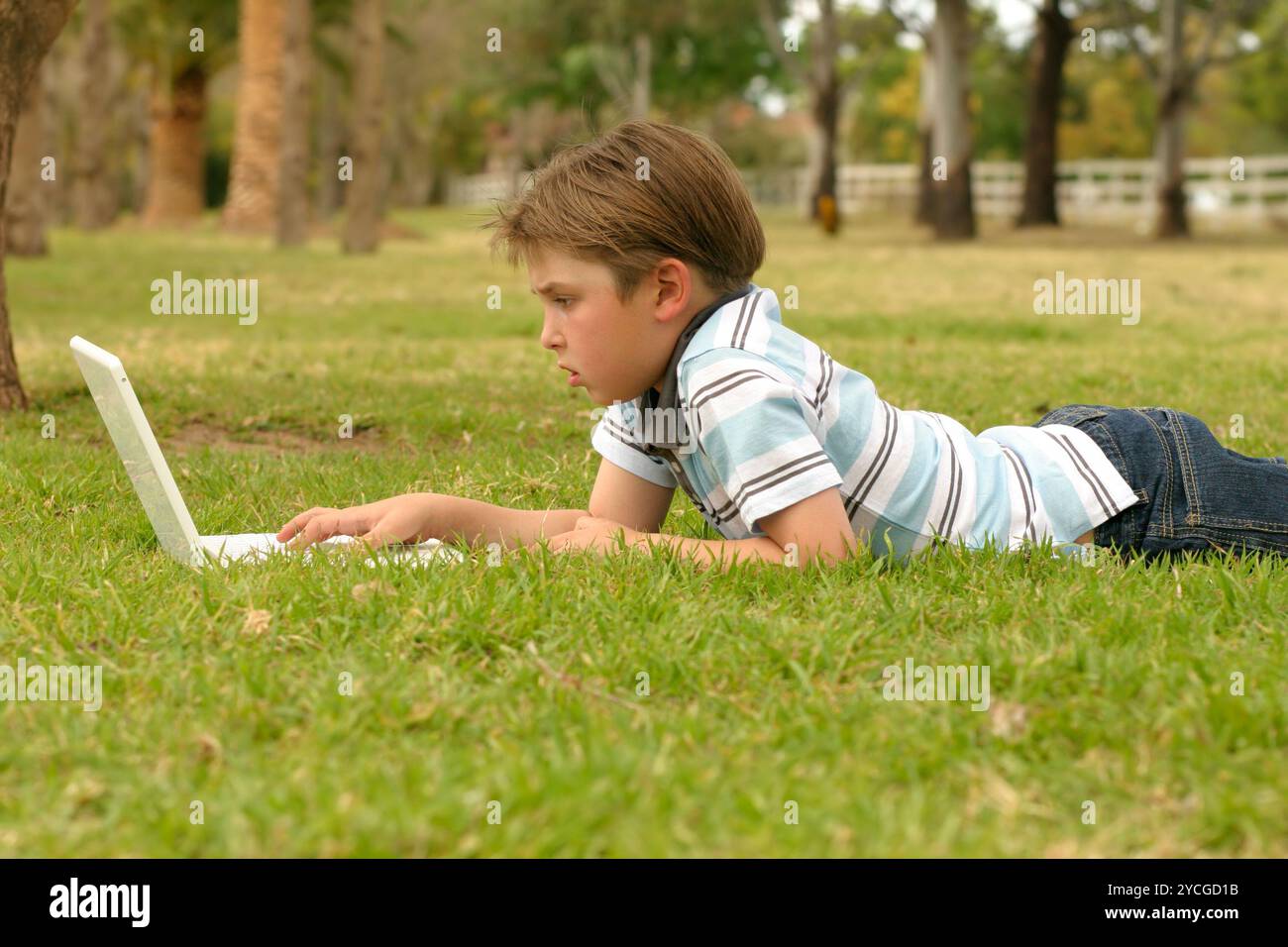 Relaxed child on laptop computer Stock Photo - Alamy