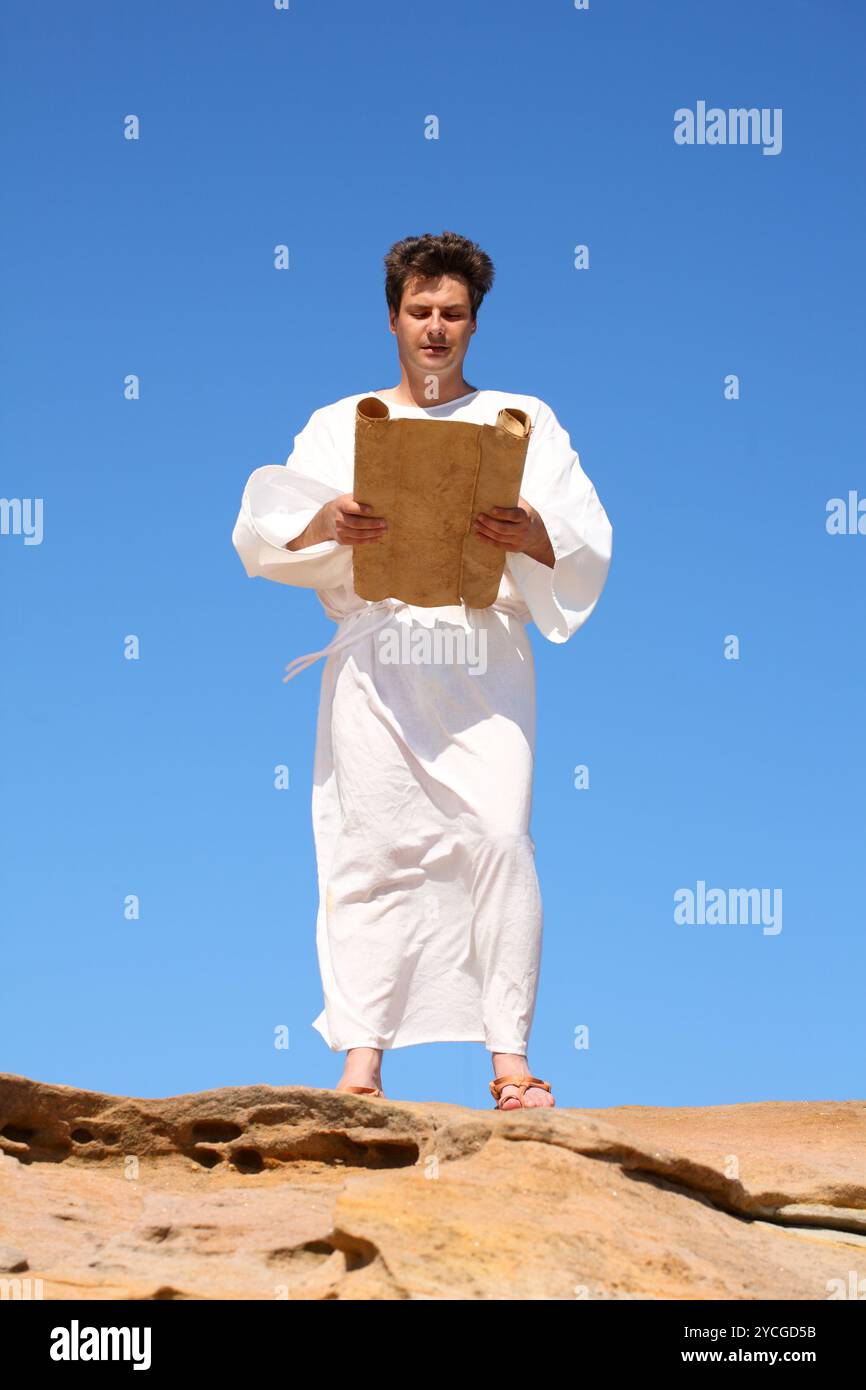 Man in robe reading Stock Photo - Alamy