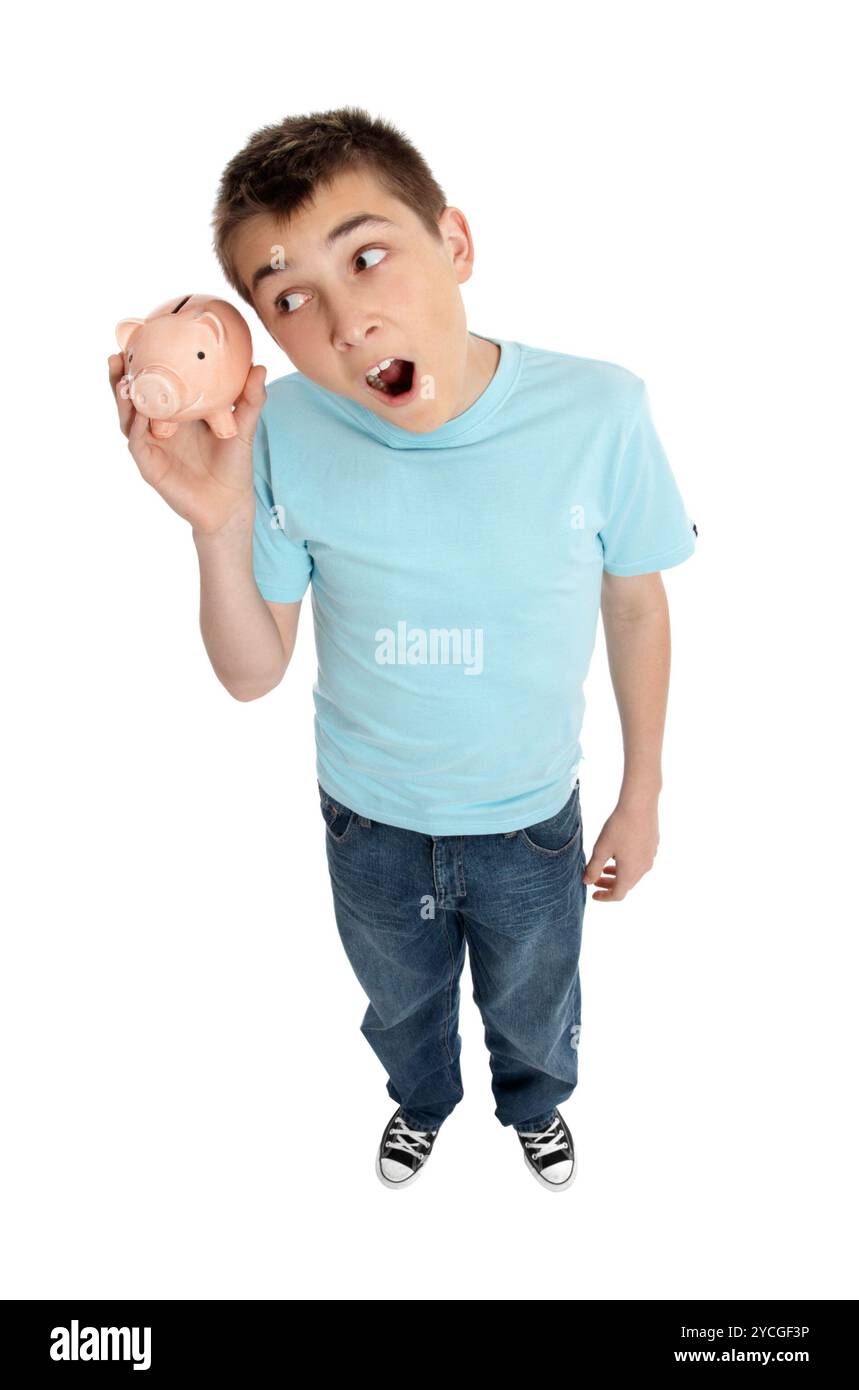 Surprised boy shaking money box Stock Photo - Alamy