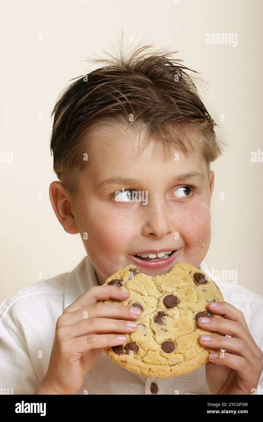 Boy with a monster Choc Chip Cookie Stock Photo - Alamy