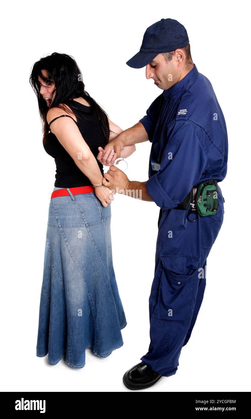 An officer apprehending a female Stock Photo - Alamy