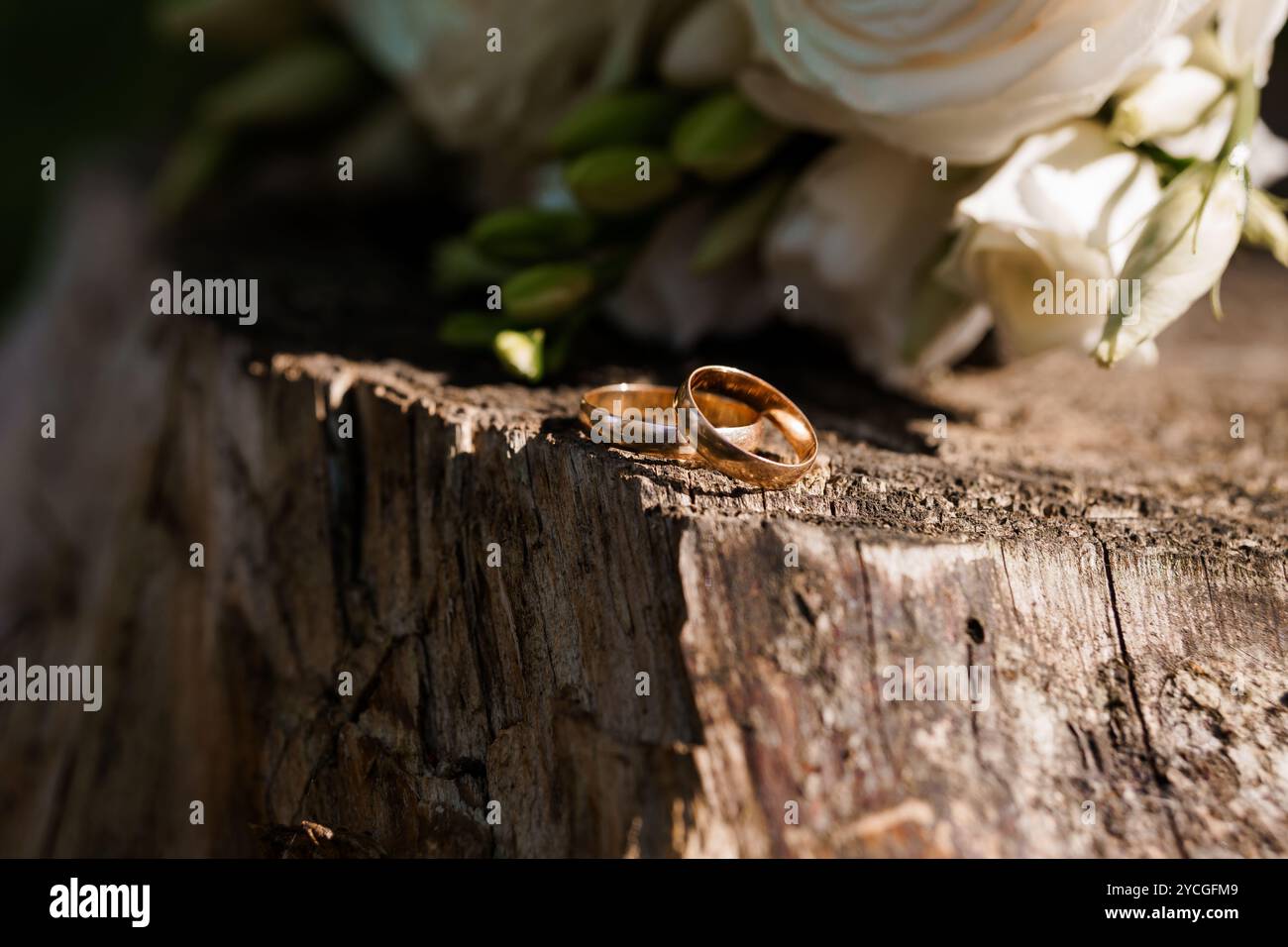 Wedding Rings on Rustic Wood with Beautiful Bouquet Background Stock ...