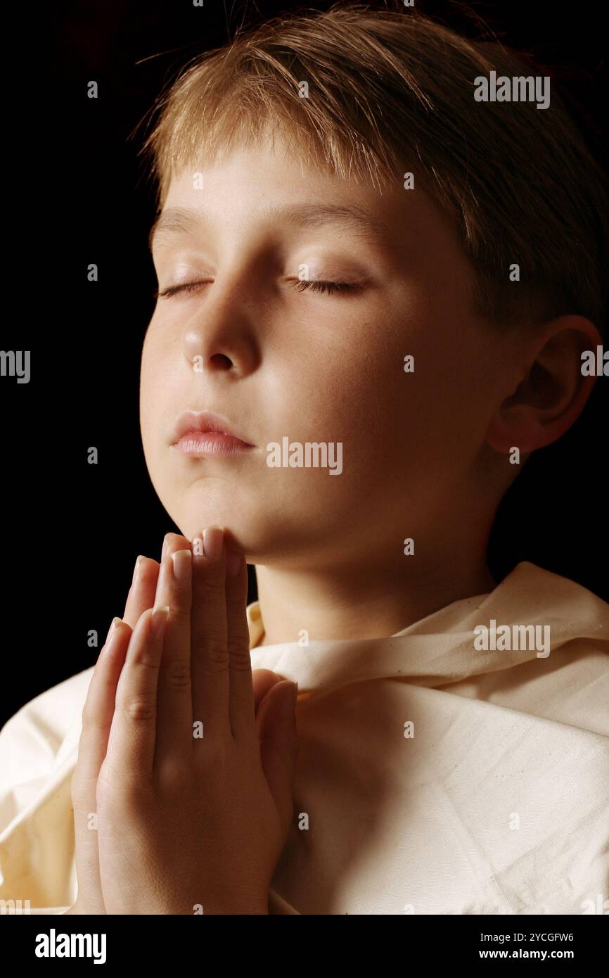 Child with hands together in prayer Stock Photo - Alamy