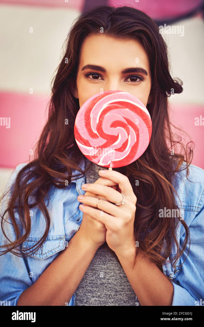 Outdoor, woman and portrait with candy for fashion with street style ...