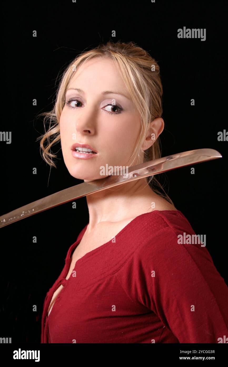 Young woman fighter or victim defeated with blade to throat Stock Photo ...