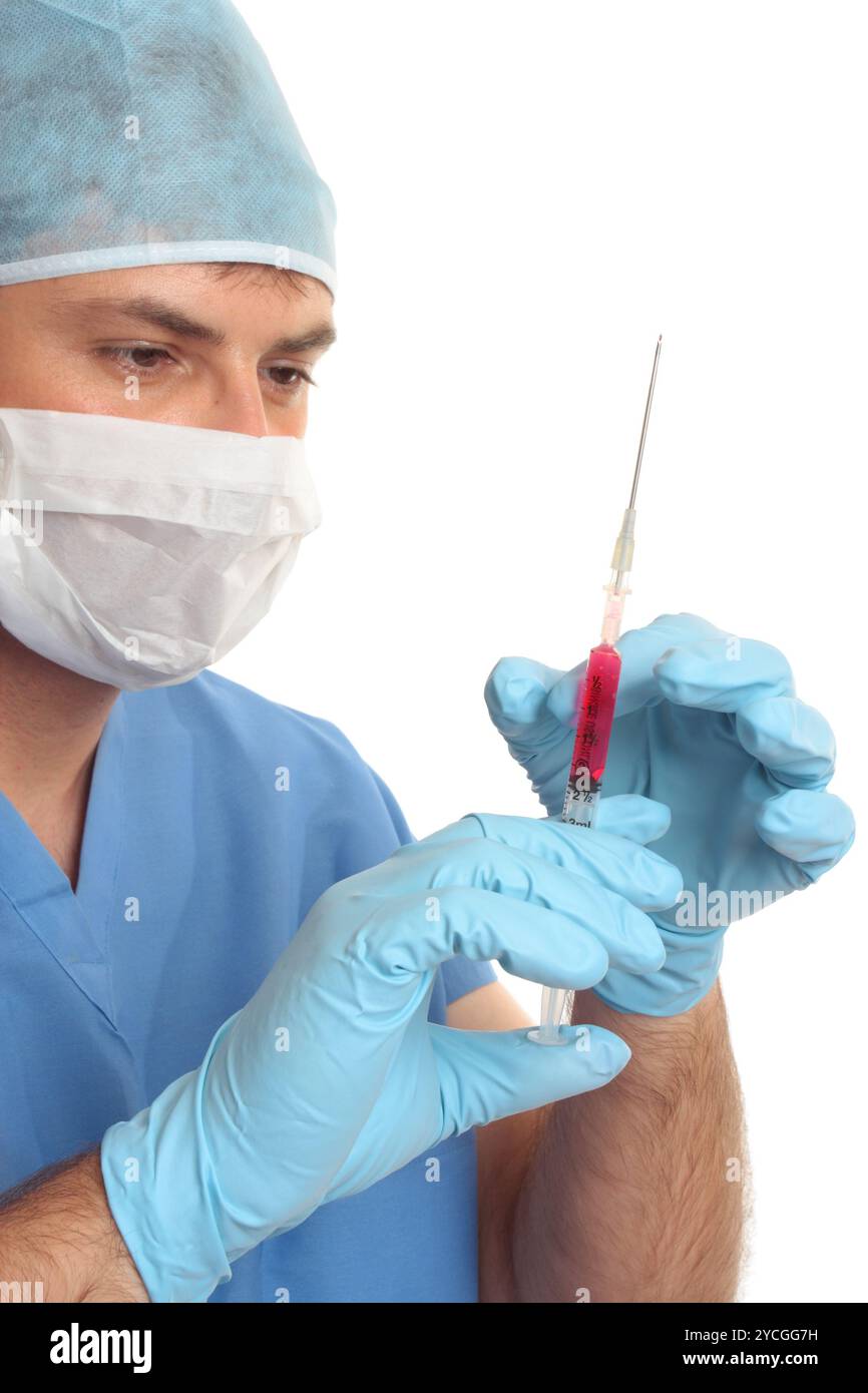 Surgeon preparing checking needle syringe Stock Photo - Alamy