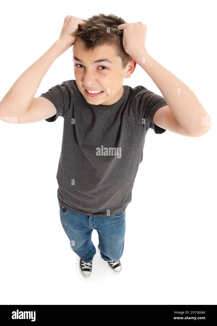 A frustrated and stressed boy or student pulling hair out and grimacing ...