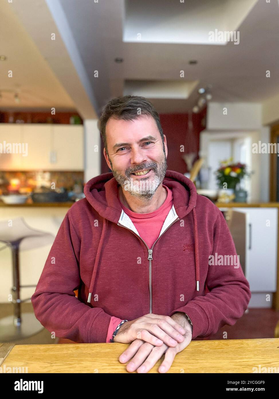 A middle aged man aged 50 happy and smiling in a home setting in ...