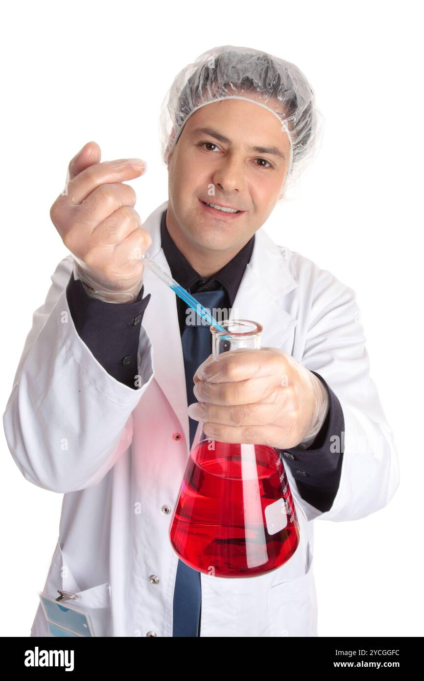 A smiling laboratory research worker adding a measured sample to a ...