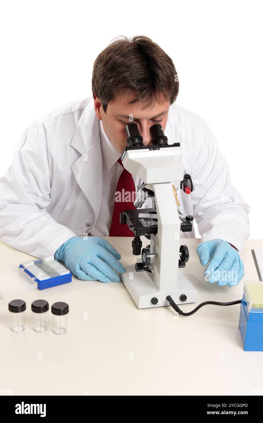 Scientist studying slide under microscope Stock Photo - Alamy