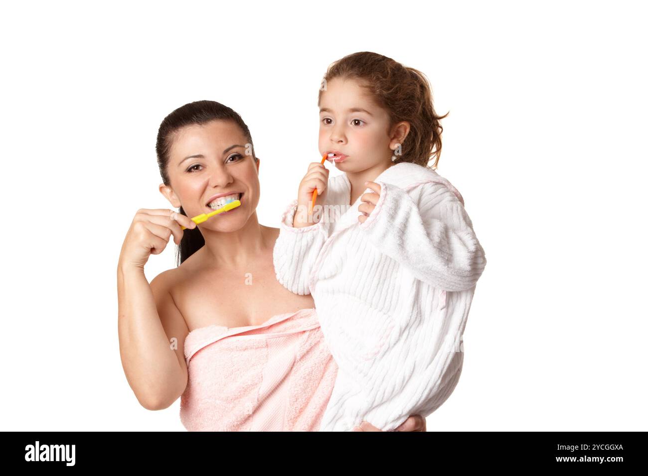 A mother and daughter brushing teeth using toothbrushes and aqua ...