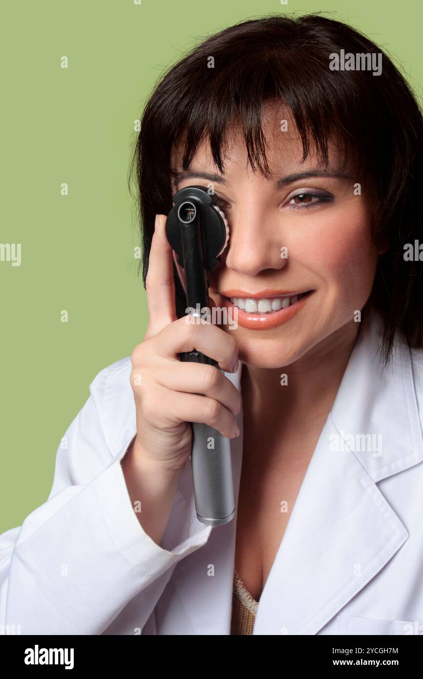 An eye doctor optometrist using opthalmoscope Stock Photo - Alamy