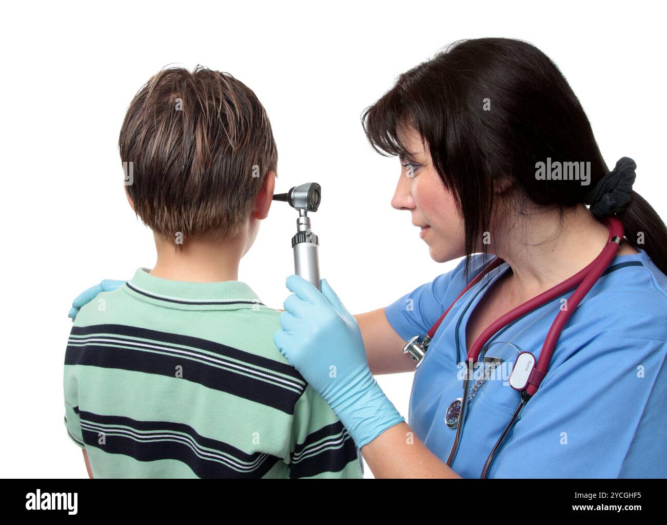 Female doctor in scrubs uniform checking a patient with ear problems ...