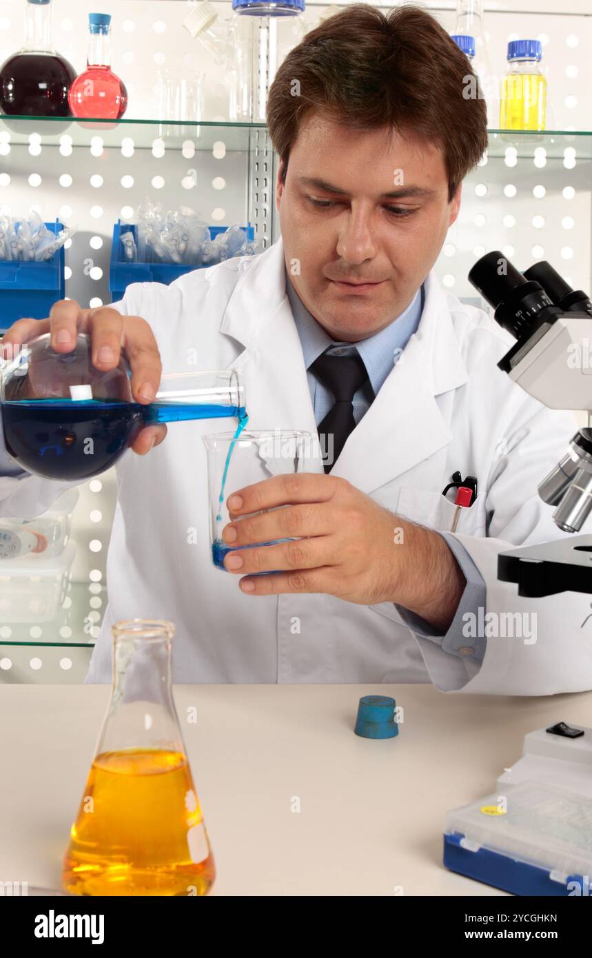 A scientist measuring liquids in a laboratory Stock Photo - Alamy