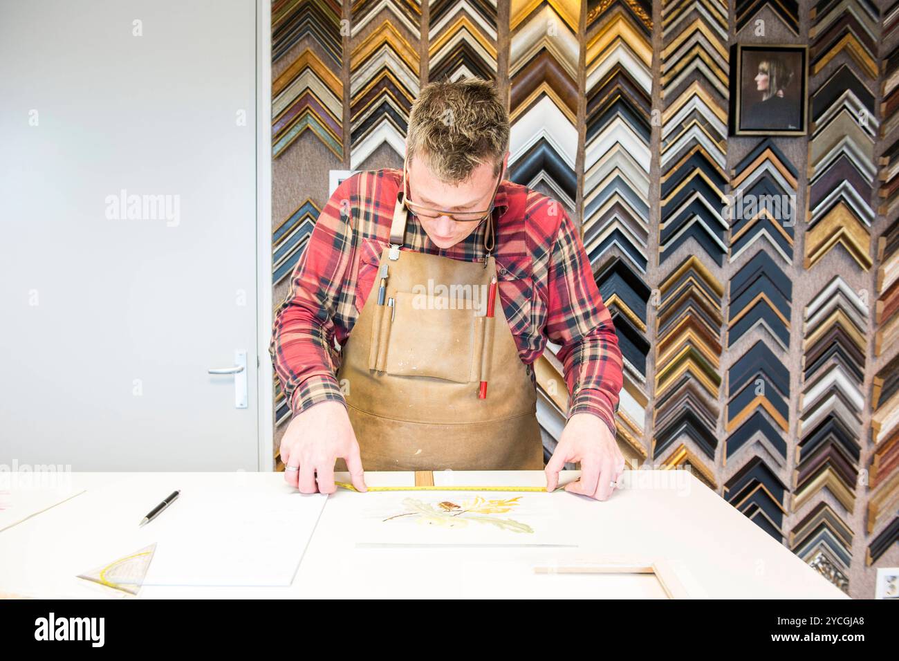 Framemaker inside his workshop Mid adult male craftsman and picture ...
