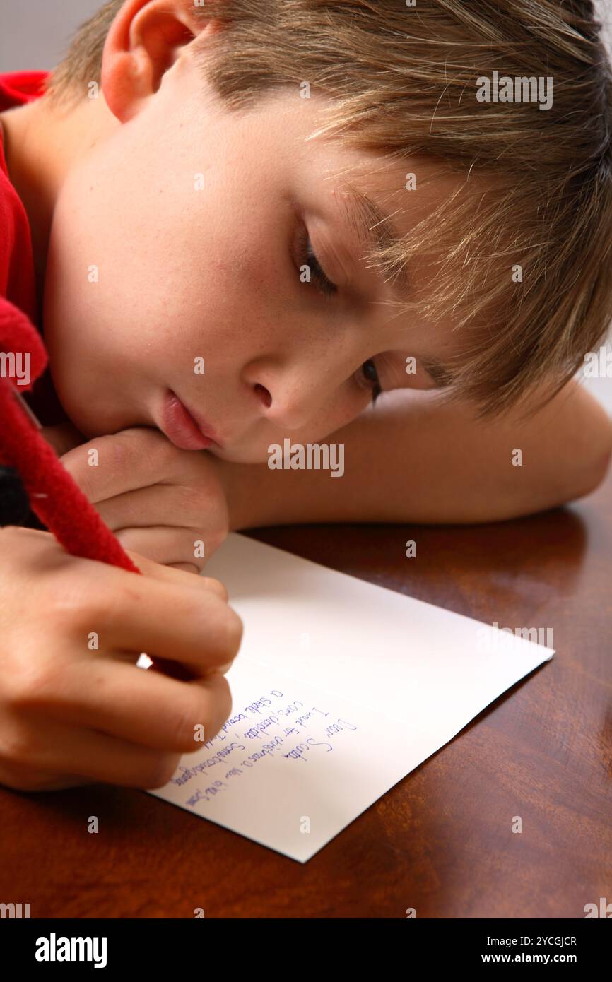 Boy writing note letter to santa Stock Photo - Alamy