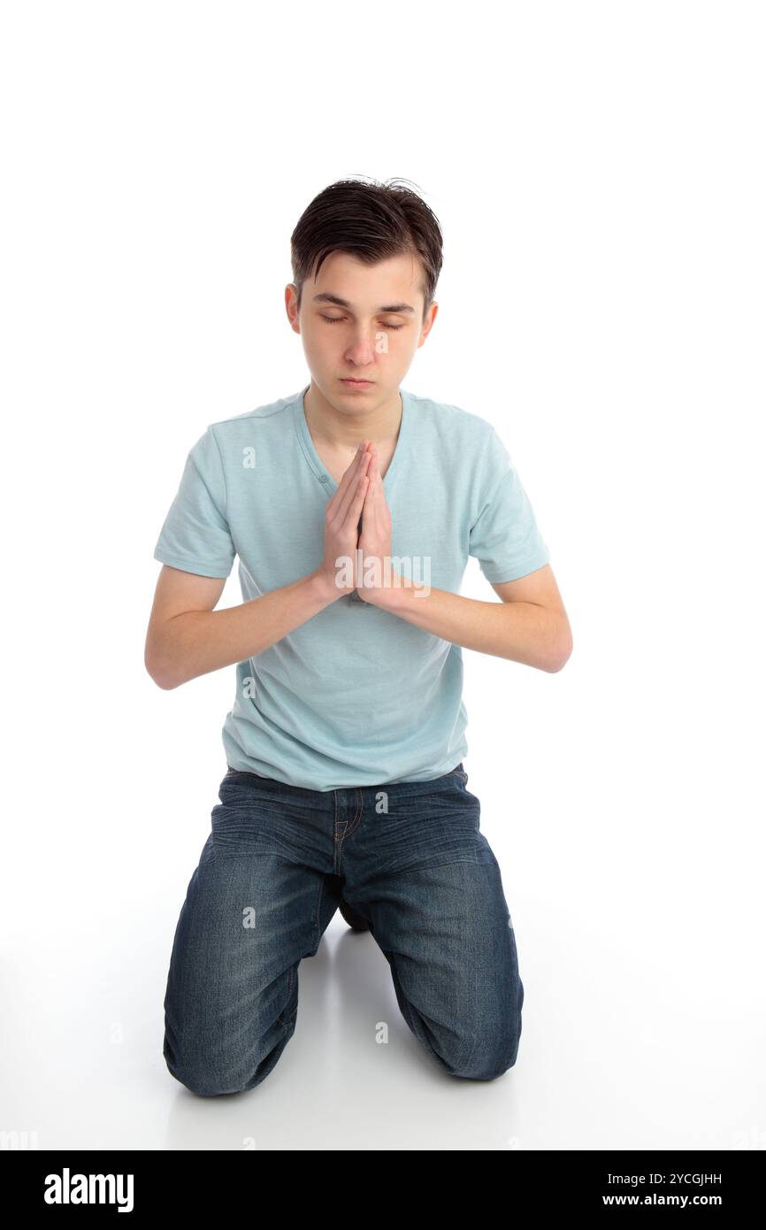 Kneeling in prayer Stock Photo - Alamy