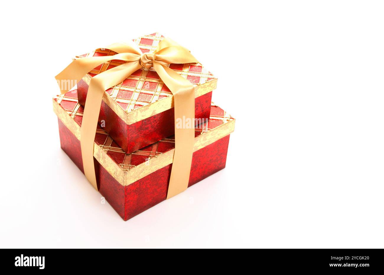 Red and metallic gold gift tield with satin ribbon on white background ...