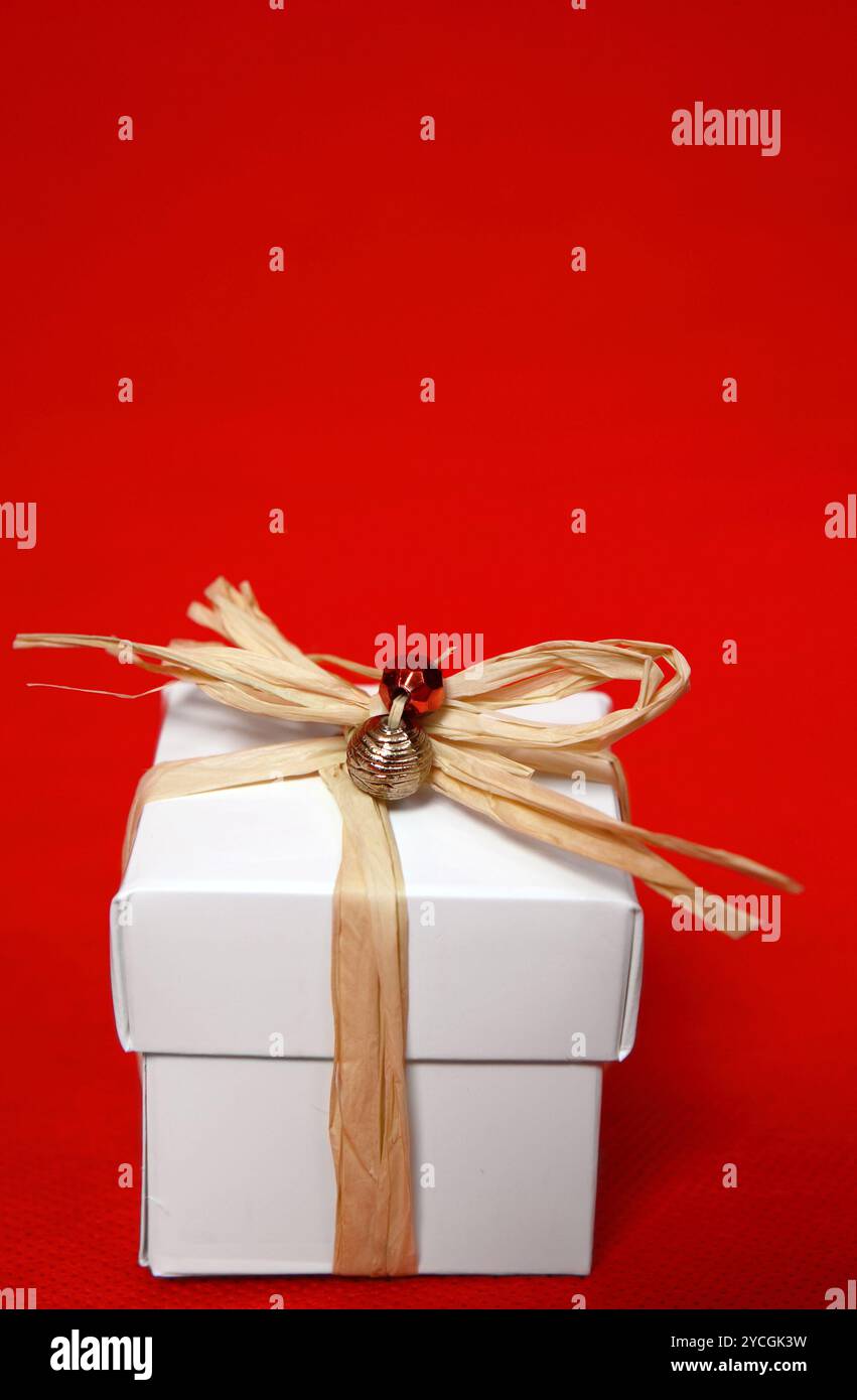 Pretty present on a red background Stock Photo - Alamy