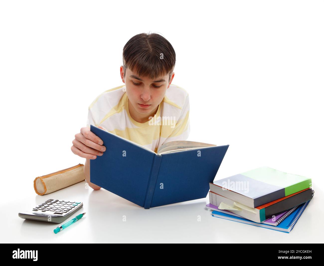 A teenage boy relaxes with study books and accessories. White ...