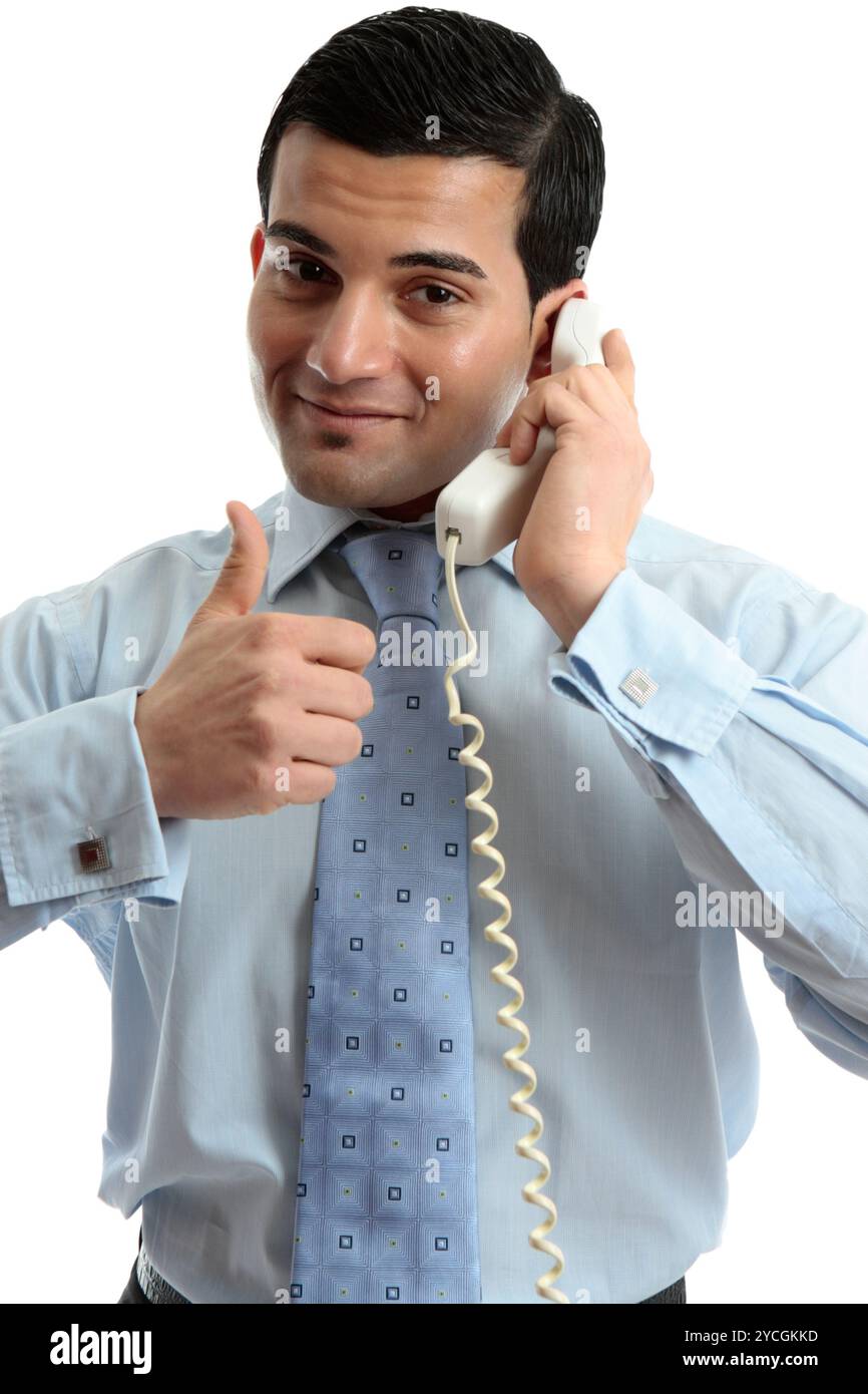 A businessman on a telephone call and with thumbs up success, approval ...