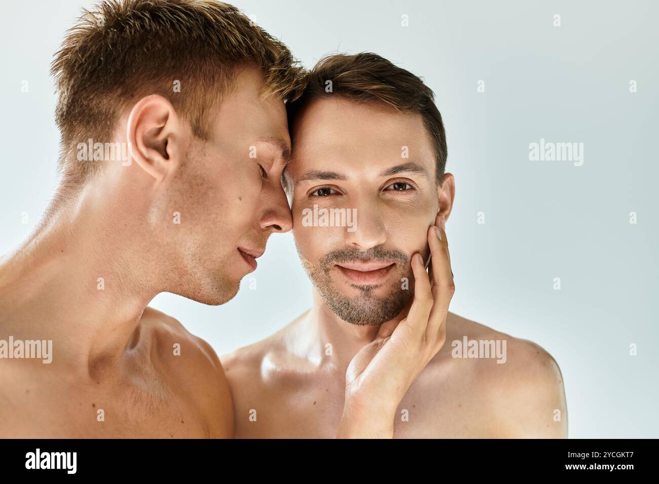 Two young men share an intimate moment, radiating love and connection ...