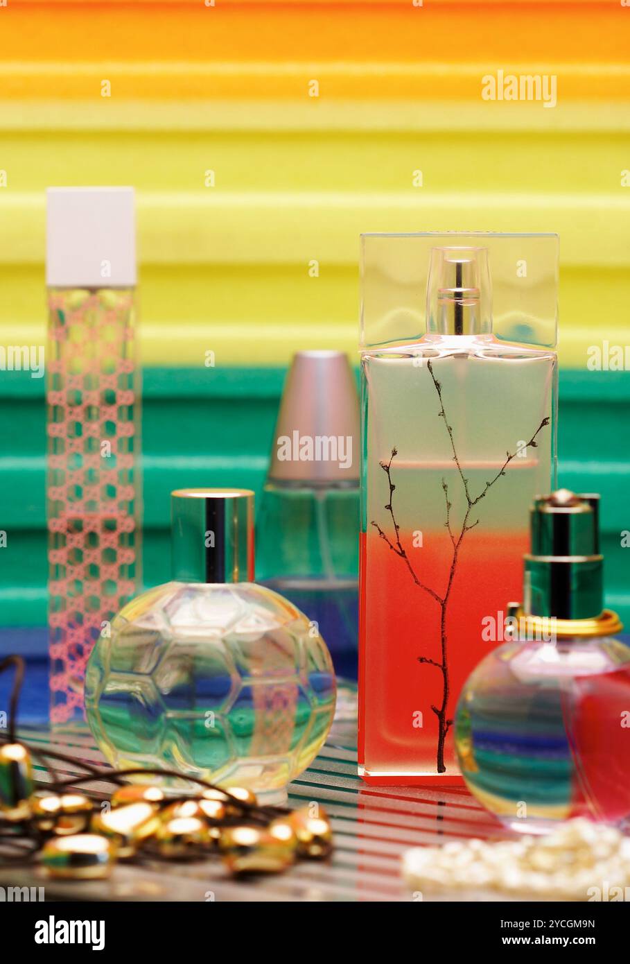 Glass bottles with perfumery. On a color background with reflection ...