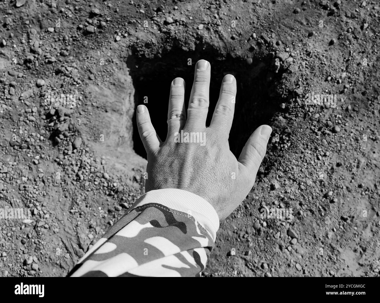 Grounded Connection: Man's Hand Framed by a Square-Shaped Dig Hole ...