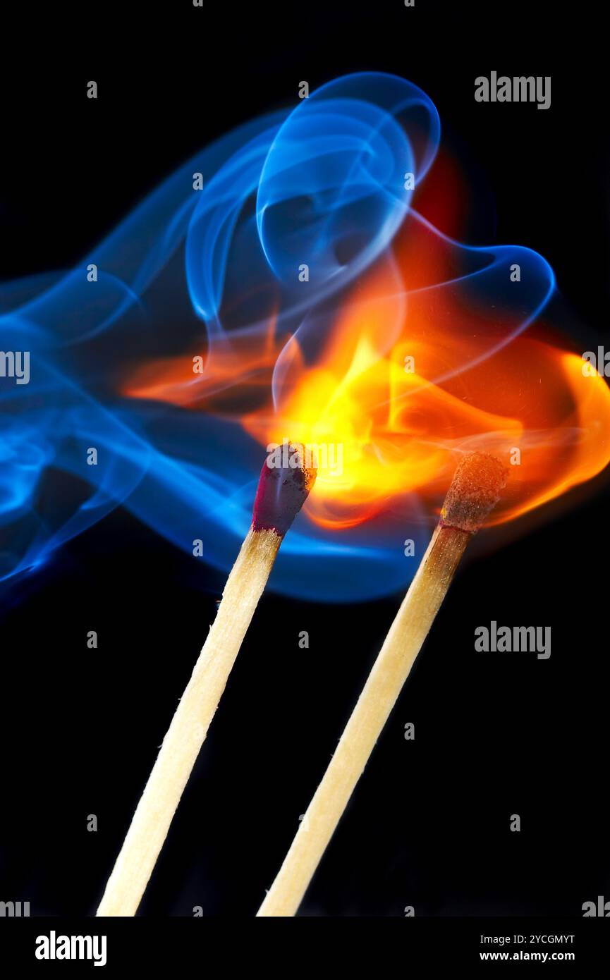 Photo of a burning match in a smoke on a black background Stock Photo ...