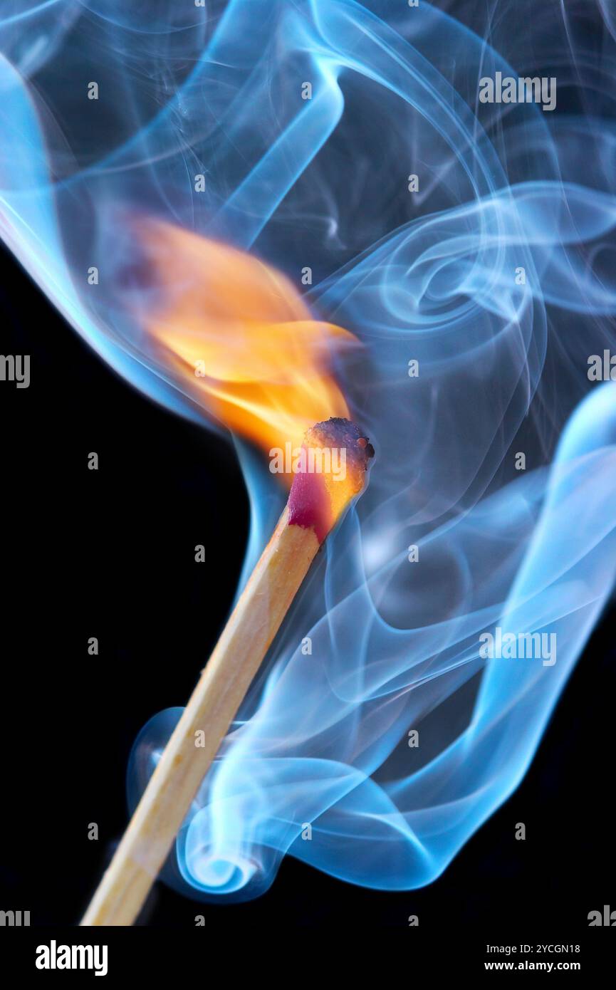 Photo of a burning match in a smoke on a black background Stock Photo ...