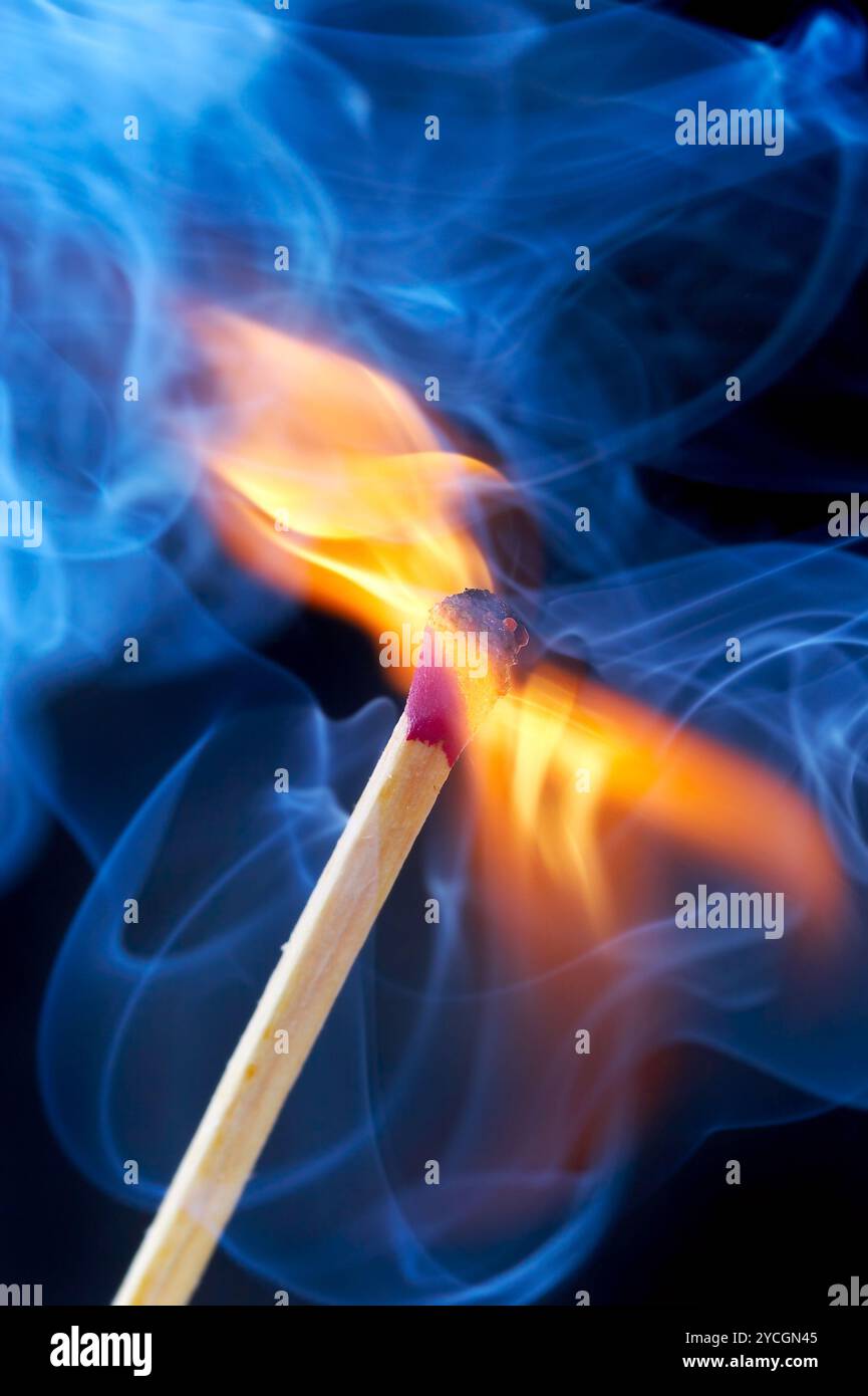 Photo of a burning match in a smoke on a black background Stock Photo ...