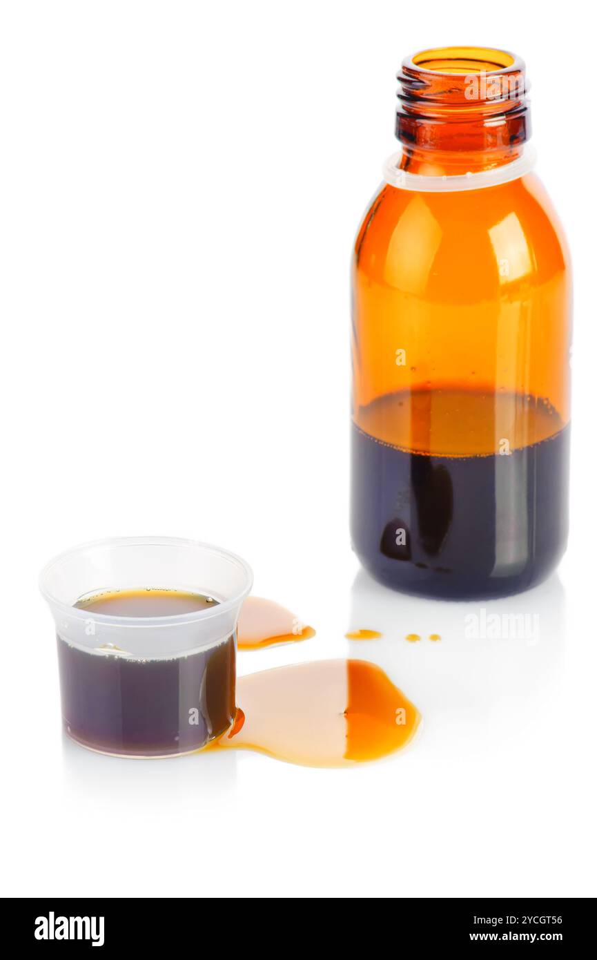 Bottle and plastic measuring cup of syrup medicati Stock Photo - Alamy