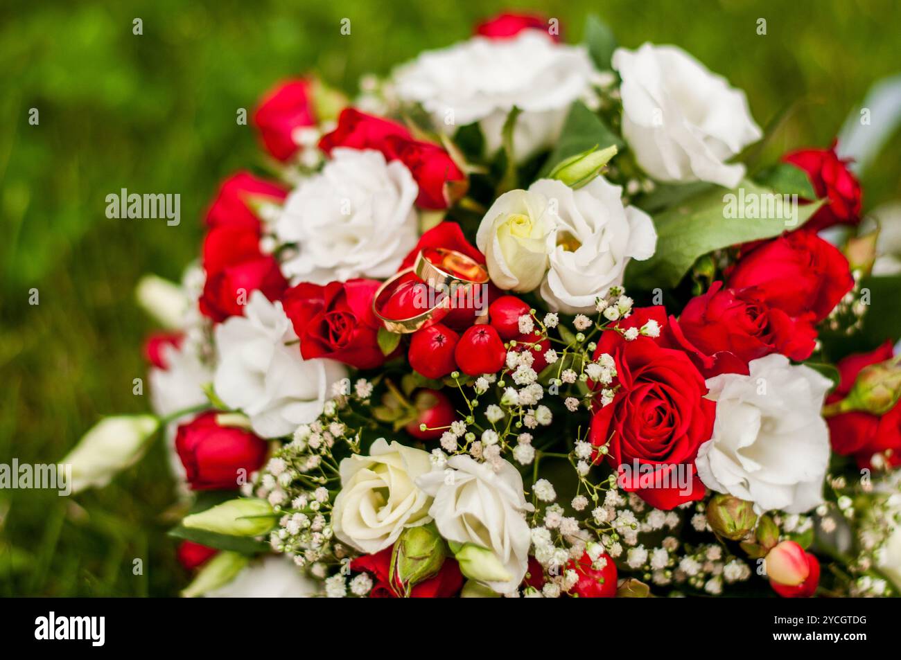 Radiant Floral Arrangement with Wedding Rings on Lush Greenery Stock ...