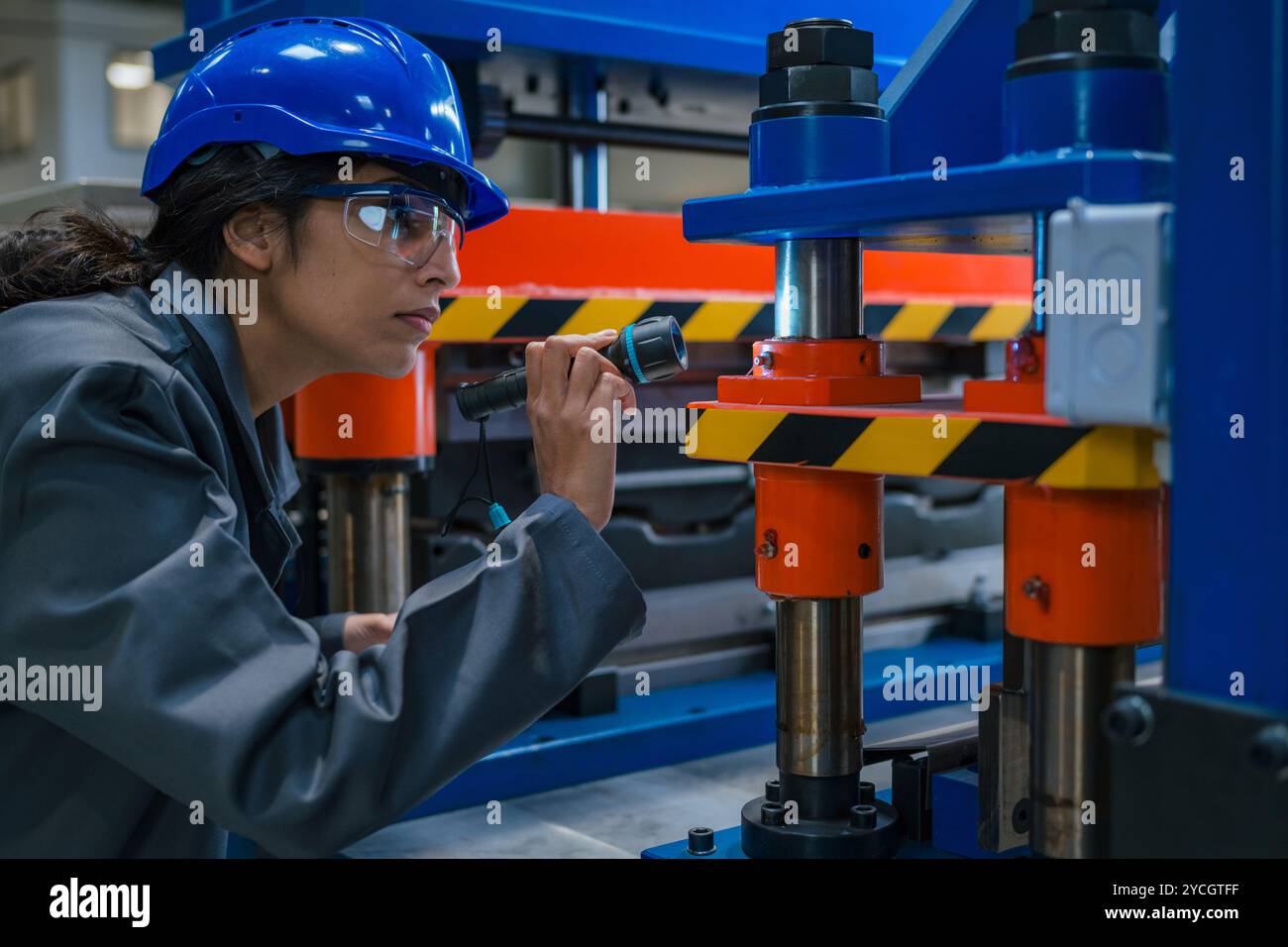 Indian female engineering technology professional holding a flashlight ...