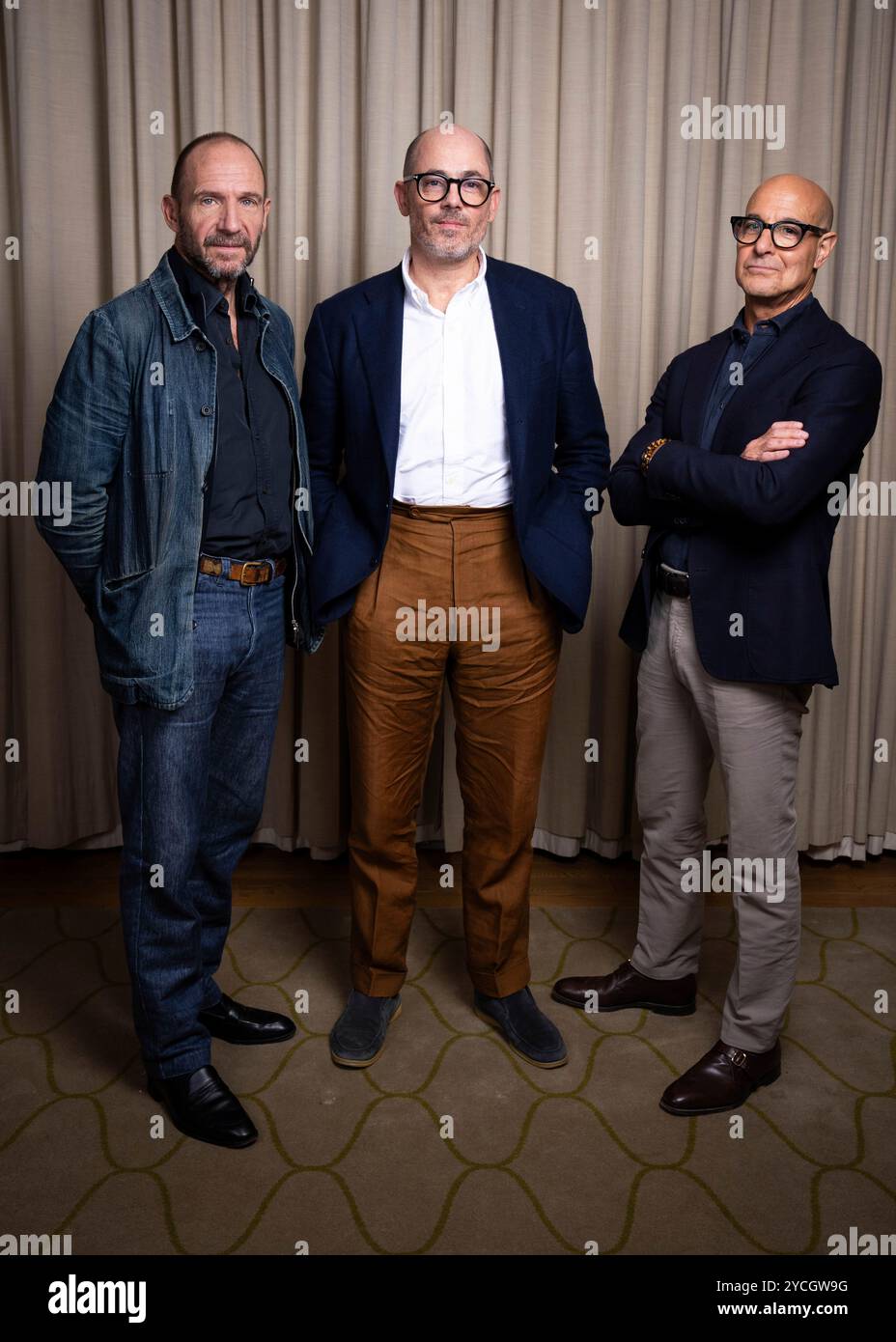 Ralph Fiennes, from left, director Edward Berger and Stanley Tucci pose ...