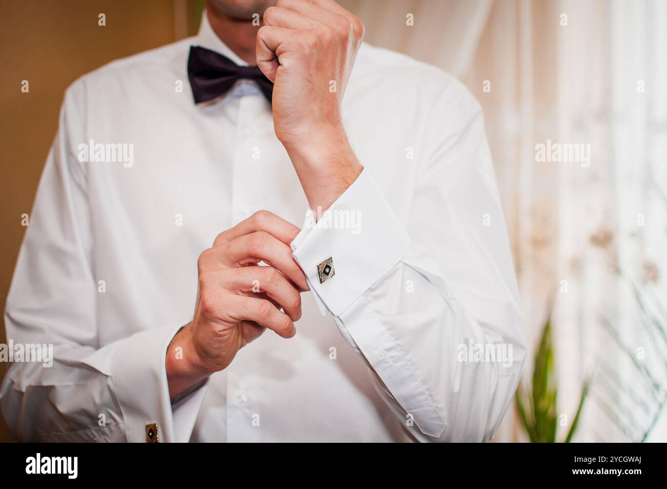 Elegant Man in Formal Attire Adjusting Cufflinks Before an Event Stock ...