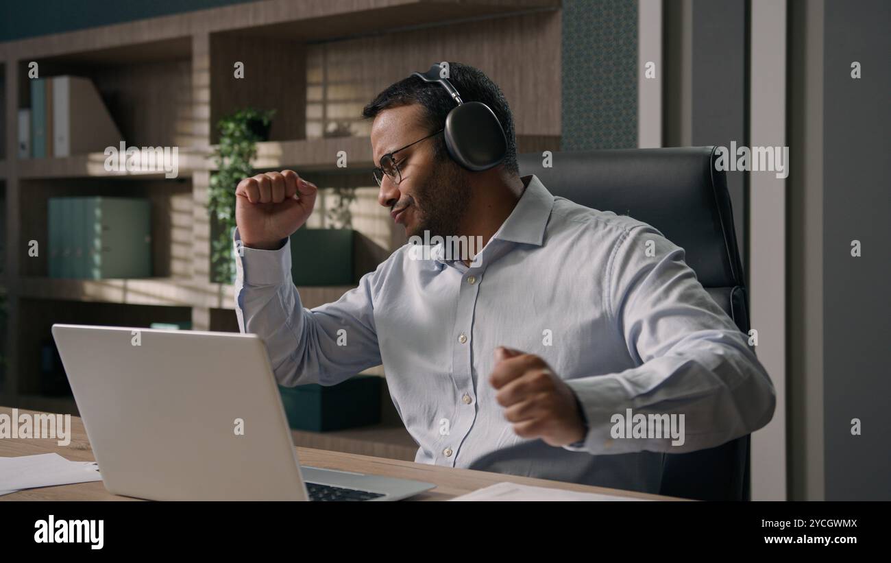 Happy employer at office table with computer laptop enjoying rest break ...