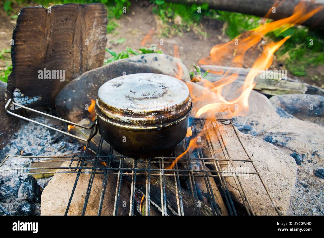 Cooking food in old tourist pot at fire place Stock Photo - Alamy