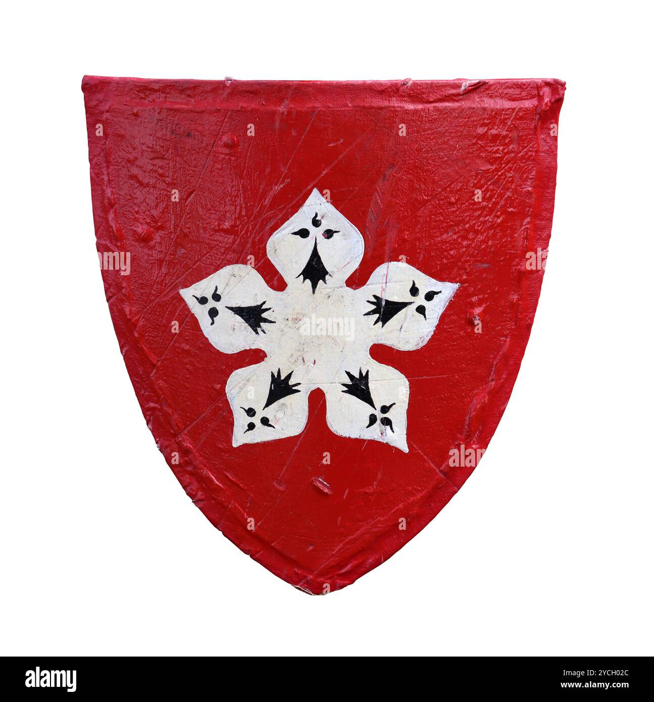 A medieval shield painted red with a flower design on the front against ...