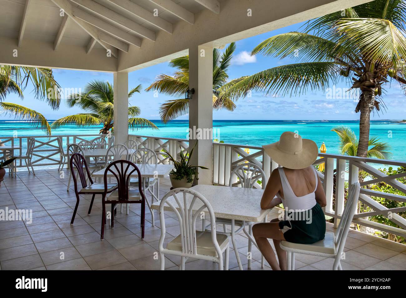 A woman looks over the beautiful waters of Shoal Bay from her chair at ...