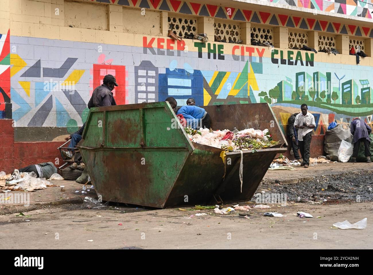 NAIROBI DOWNTOWN, KENYA - NOVEMBER 19, 2022: Poor people rummage ...