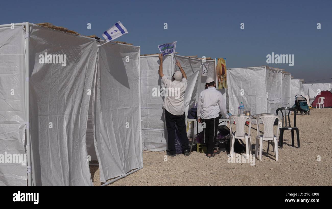 SOUTHERN BORDER, ISRAEL - OCTOBER 21: Religious Jewish men set up a ...