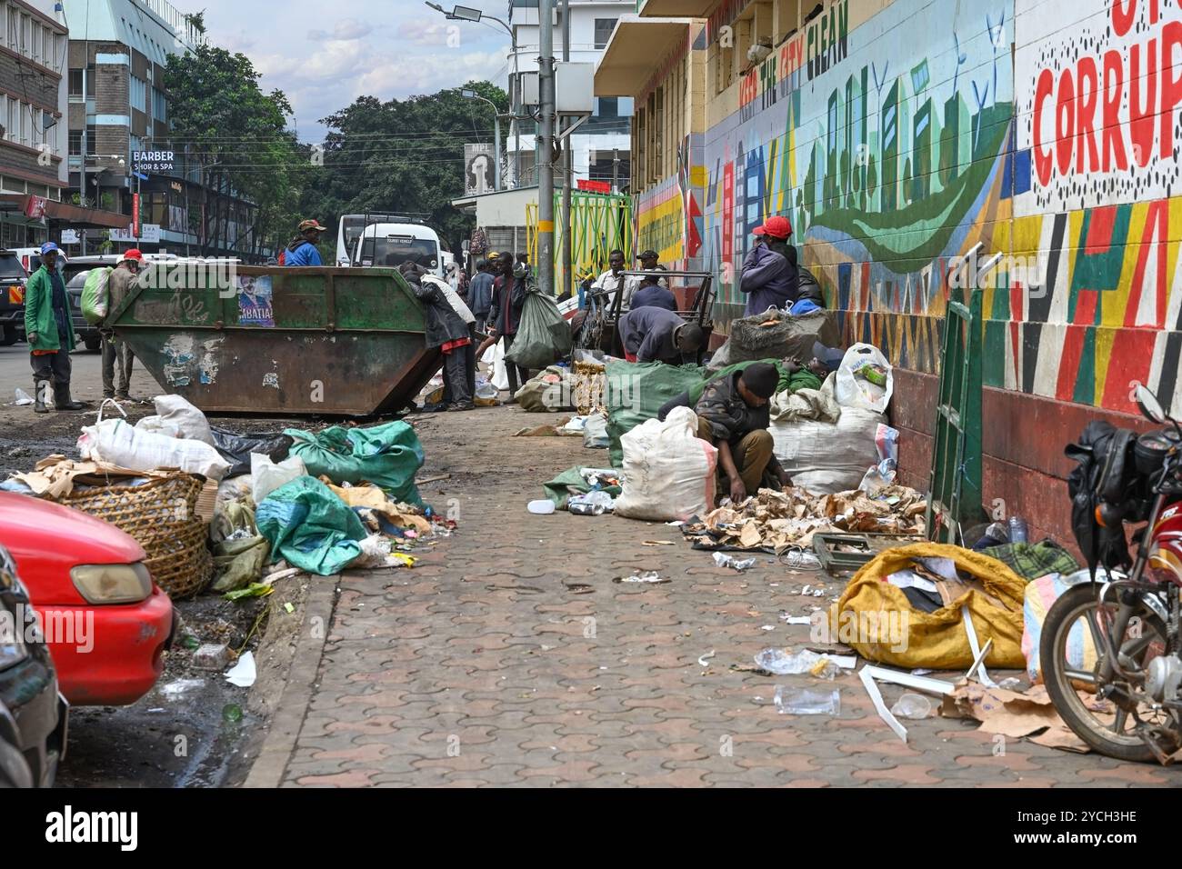 NAIROBI DOWNTOWN, KENYA - NOVEMBER 19, 2022: Poor people rummage ...