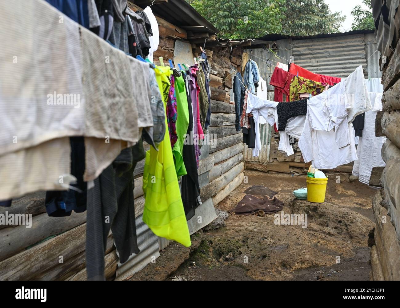 Narrow streets with drying laundry in Kibera slum in Nairobi. The ...